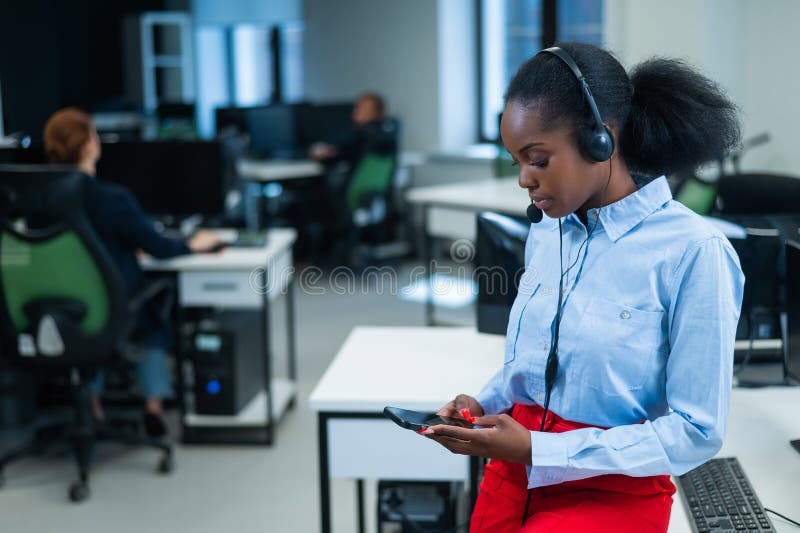 African Female Call Center Employee Using Smartphone. Stock Image ...