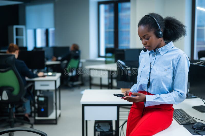 African Female Call Center Employee Using Smartphone. Stock Image ...
