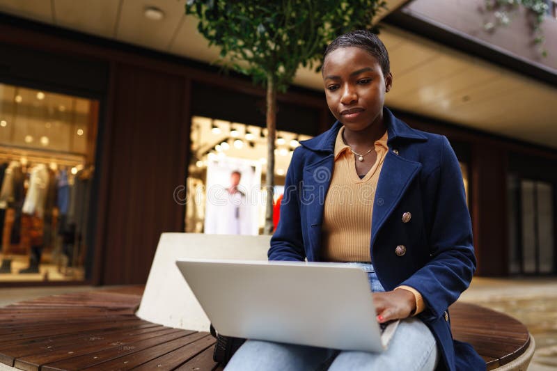 African Female Student Working on Computer in Public Place Stock Photo ...