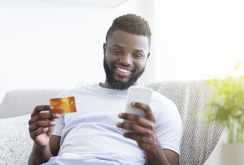African Guy Making Transaction Online Using Mobile Application Stock ...