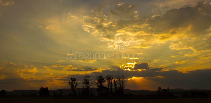 African Landscape with Sunset Clouds and Sunlight Rays Stock Photo ...