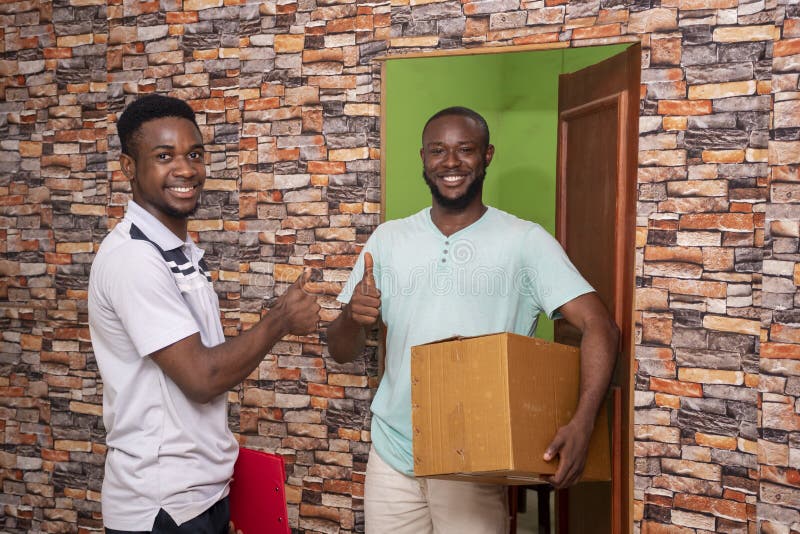 African Male Receiving a Parcel from a Delivery Service Worker Stock ...