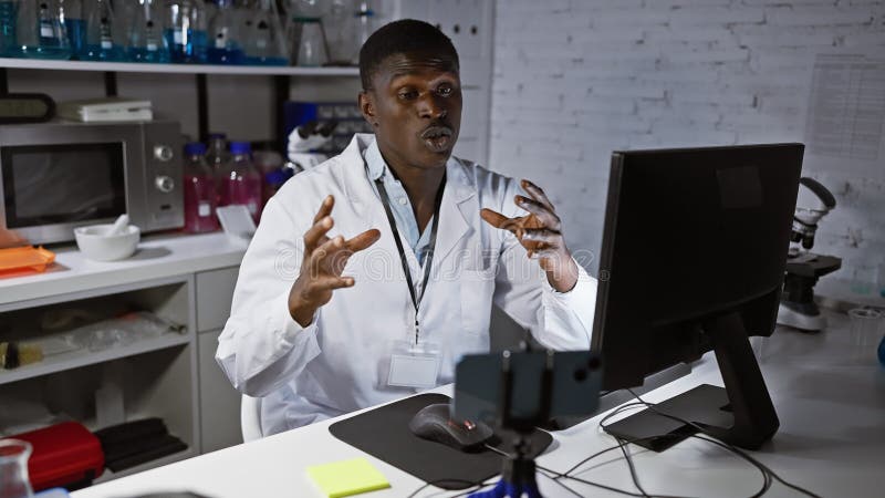 African Male Scientist Explaining Research in a Laboratory while Live ...