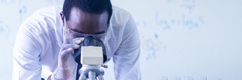 African Male Scientist Looking in Microscope in Laboratory, Testing for ...