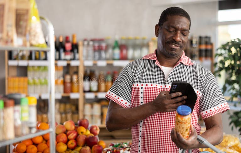 African Man Customer at Shop Scans QR Code on Canned Beans Jar Using ...
