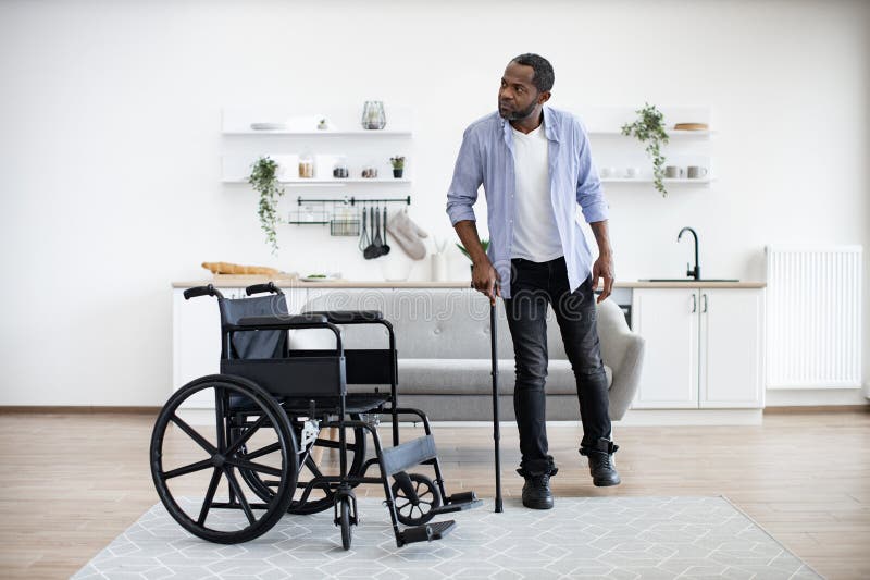 African Man Disability Using Walking Stick Raising Wheelchair Stock ...