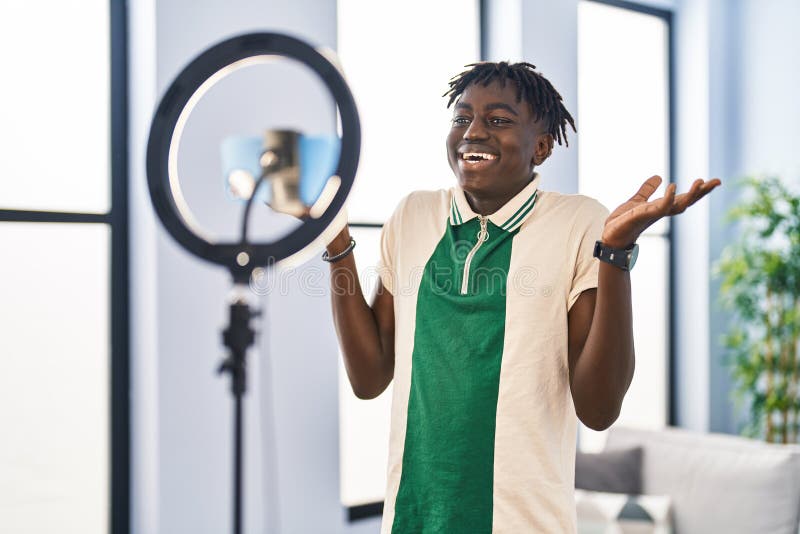 African Man with Dreadlocks Recording Vlog Tutorial with Smartphone at ...