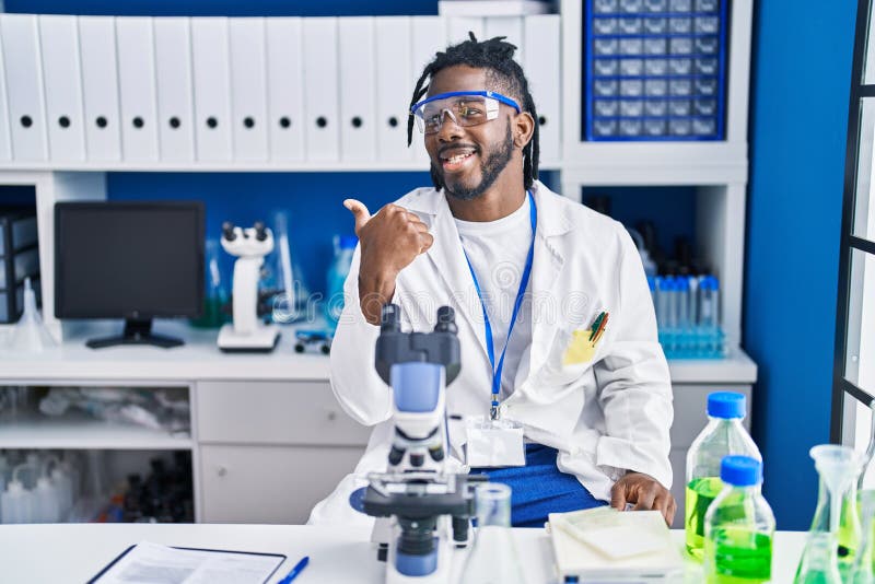 African Man with Dreadlocks Working at Scientist Laboratory Pointing ... African Man with Dreadlocks Working at Scientist Laboratory Pointing ...