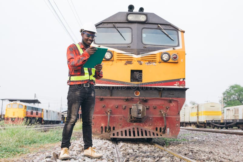 African Man Engineer Looking Report of Train Timetables for Control a ...