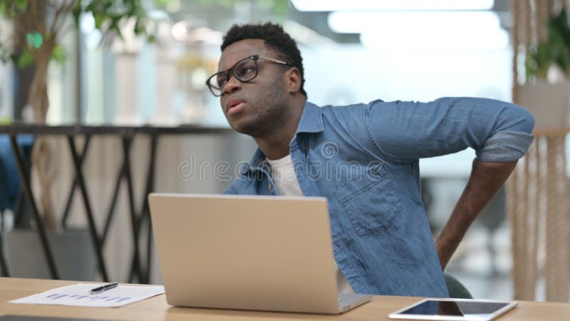 African Man Having Back Pain while Using Laptop Stock Image - Image of ...