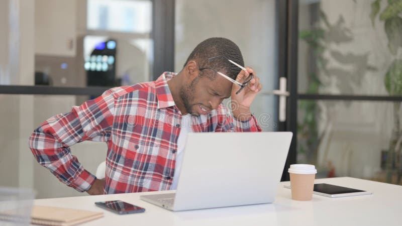 African Man Having Back Pain while Using Laptop Stock Photo - Image of ...