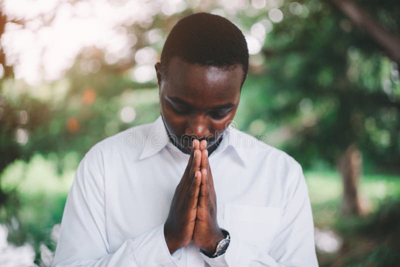 African Man Having Put Hands Together In Prayer Or Meditation Hoping