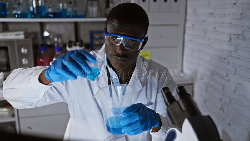 African Man in Lab Conducting Research with Beaker and Microscope Stock ...