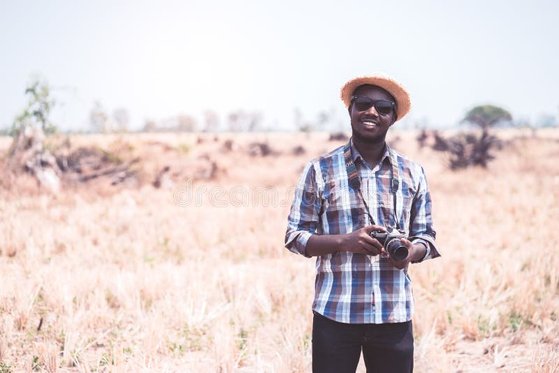 African Man Photographer Holding Camera on a Dry Field Stock Image ...