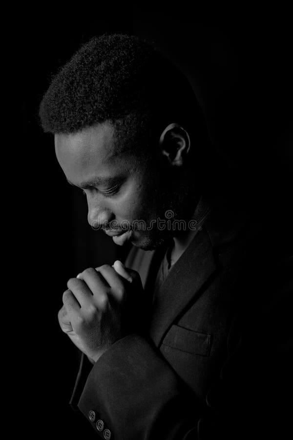 African Man Praying for God in the Dark Room.Low Key Lighting Style ...