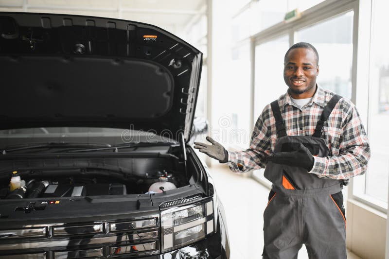 African Man Standing in a Car Repair Shop Stock Image - Image of check ...