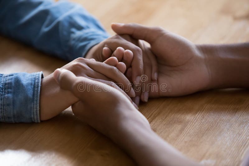 African Man Touching Hands of Young Girlfriend Over Table Surface Stock ...