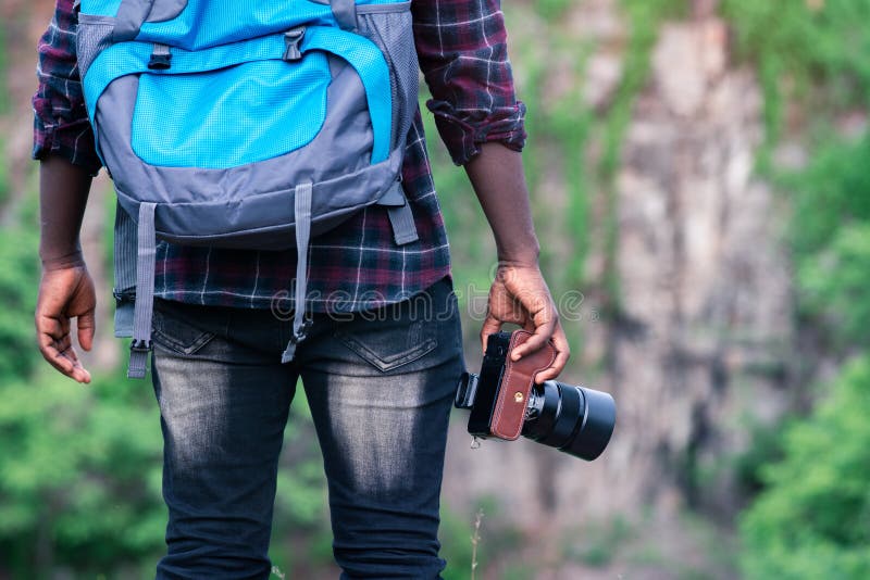 African Man Traveler Holding Camera with Backpack Stock Image - Image ...