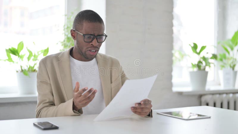 African Man Reading Documents at Work, Paperwork Stock Footage - Video ...