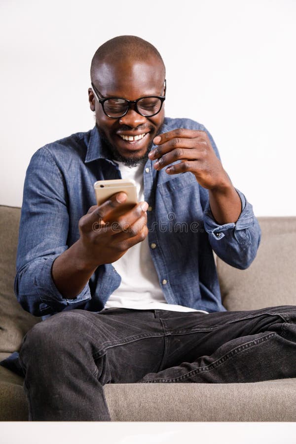 African Man Using Cellphone Stock Image - Image of screen, home: 155327311