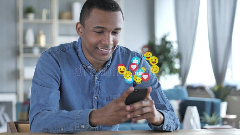 African Man Using Smartphone, Emojis, Smileys and Likes Stock Photo ...