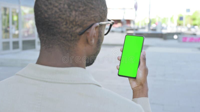African Man Using Smartphone with Green Screen Outdoor Stock Image ...