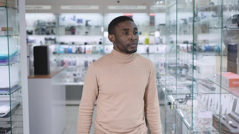 African Man in Electronics and Gadgets Department. a Man Chooses a New ...