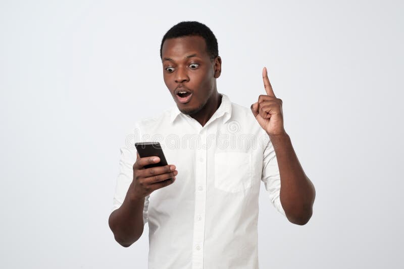 Man in White Shirt Playing Mobile Game with Shocked Face Stock Photo ...