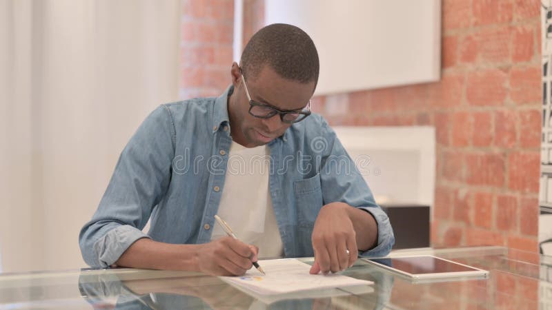 African Man Working on Documents, Doing Paperwork Stock Footage - Video ...