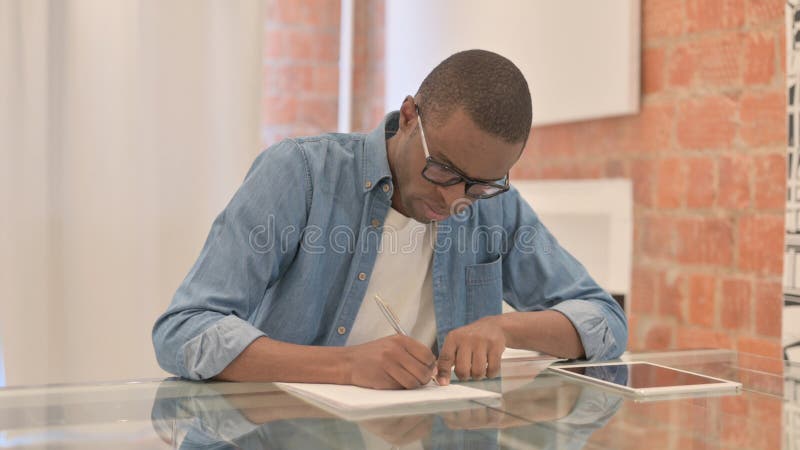 African Man Writing Letter at Work Paperwork Stock Photo - Image of ...
