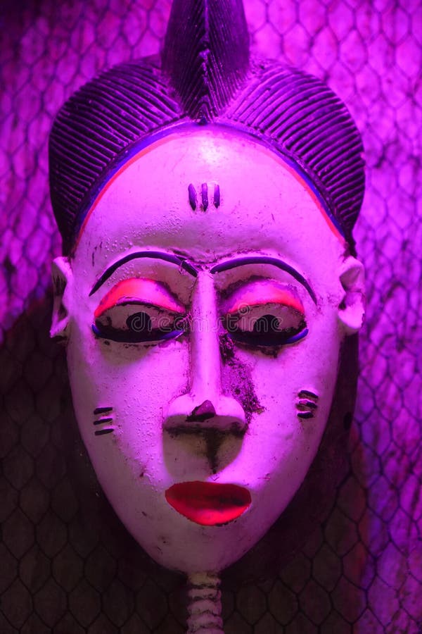 African Mask Under Violet Light Stock Photo - Image of craftsmanship ...