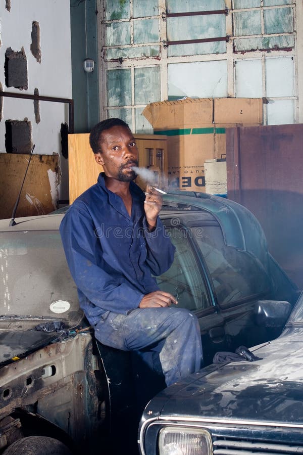 African mechanic smoking stock photo. Image of dusty, cheap - 7456620