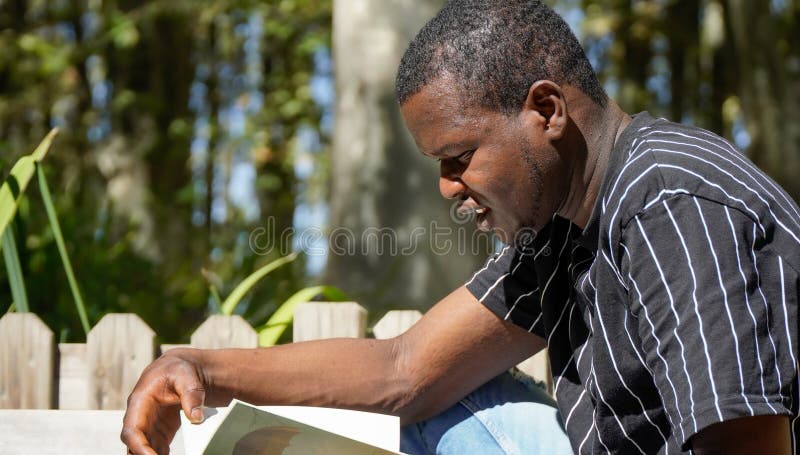African Person Reading a Book Outside. Black Man Reading Stock Image ...