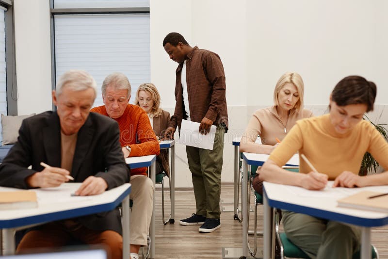Teacher Working with Senior Students in Class Stock Image - Image of ...