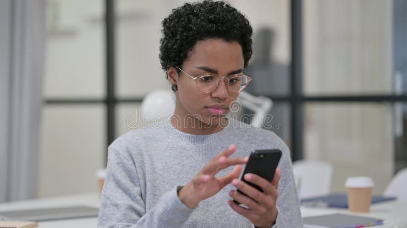 African Woman Browsing Internet on Smartphone Stock Photo - Image of ...