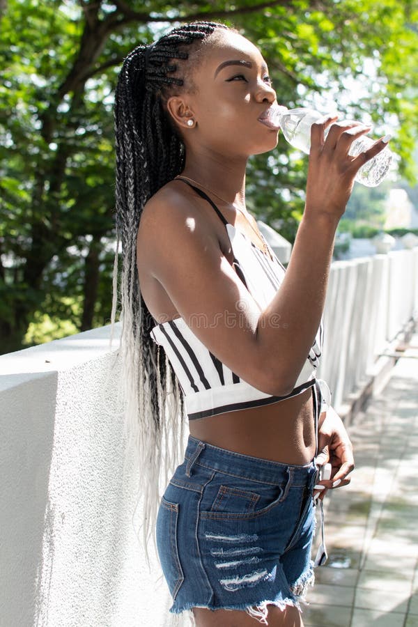 African Woman Drinking Water from Plastic Water Bottle Stock Image ... African Woman Drinking Water from Plastic Water Bottle Stock Image ...