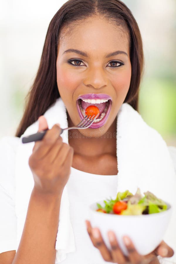 African woman eating salad stock image. Image of food - 33777313