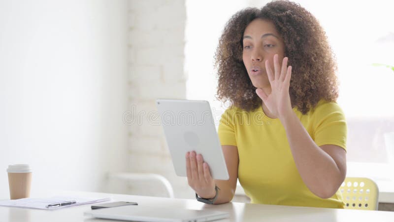 African Woman Making Video Call on Tablet in Office Stock Image - Image ...