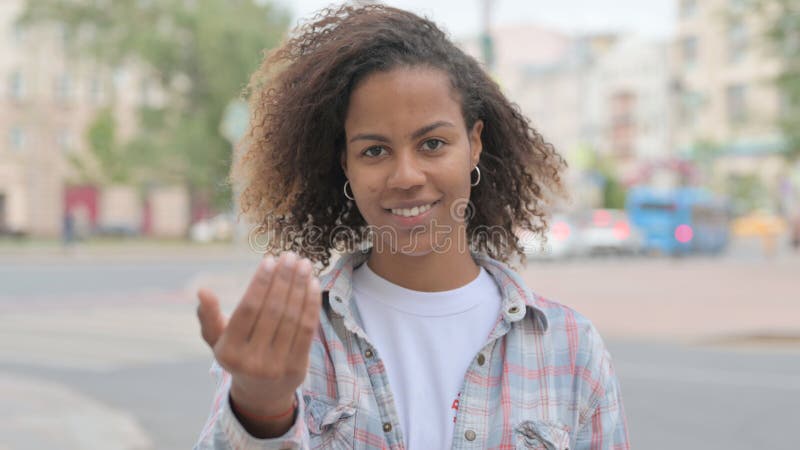 African Woman Pointing at the Camera and Inviting Outdoor Stock Photo ...