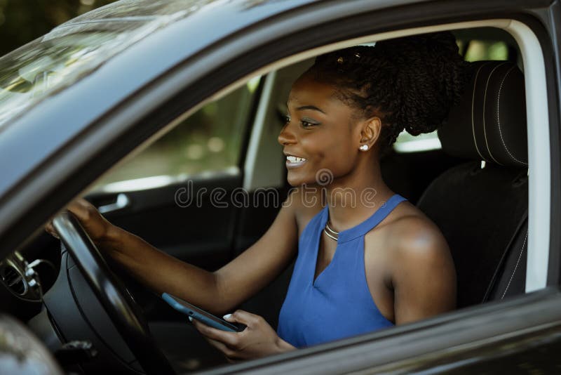 African Young Woman Using Mobile Phone while Driving Car Stock Photo ...
