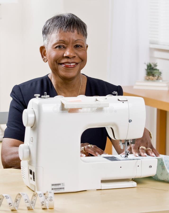 Woman Using Sewing Machine at Home Stock Photo - Image of lifestyle ...