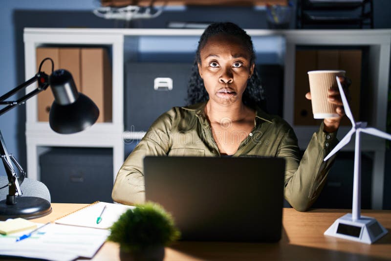 African Woman Working Using Computer Laptop at Night Depressed and ...