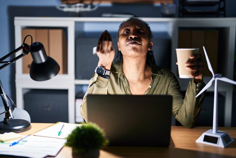 African Woman Working Using Computer Laptop at Night Doing Italian ...