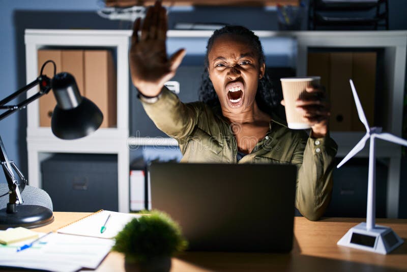 African Woman Working Using Computer Laptop at Night Doing Stop Gesture ...