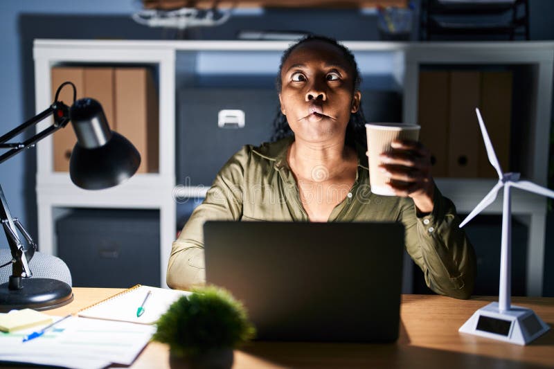 African Woman Working Using Computer Laptop at Night Making Fish Face ...