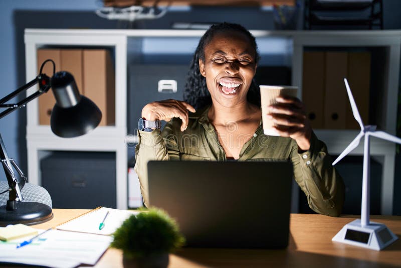 African Woman Working Using Computer Laptop At Night Sticking Tongue