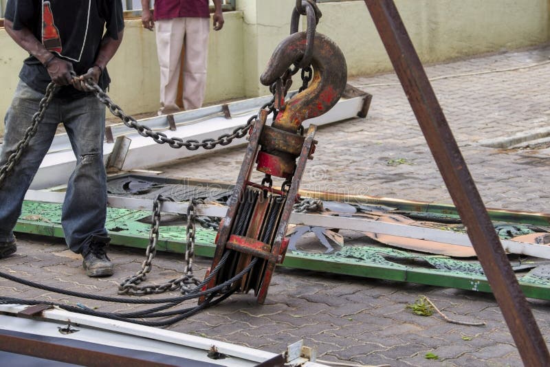 African Worker Using a Chain on a Crane Hook Stock Image - Image of ...