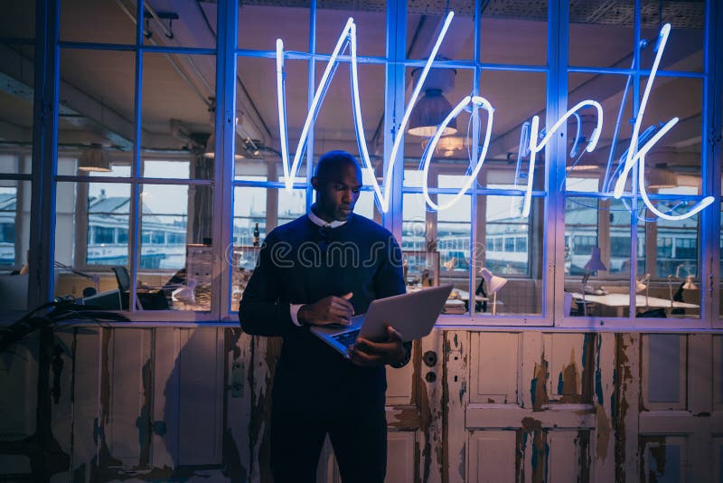 African Young Man Standing in Office Using Laptop Stock Image - Image ...