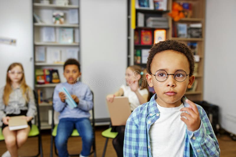 Schoolboy Standing in Middle of Classroom and Answering Question in ...