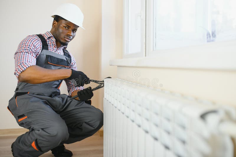 Afro Repairman in Blue Using Tools while Installing or Repairing ...